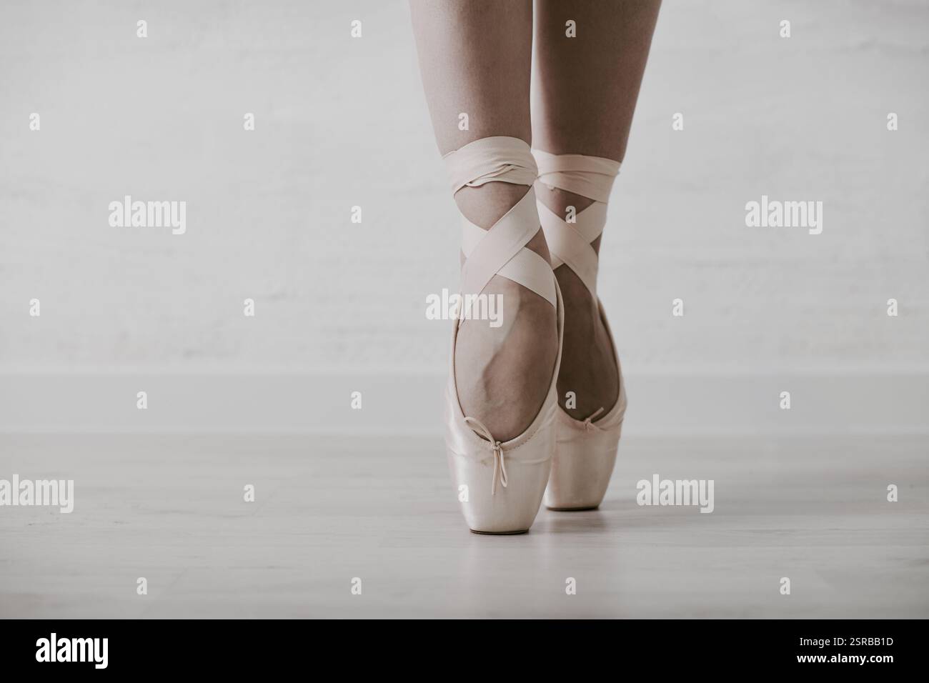 Close-up of young female adult ballet dancers feet in pointe shoes ...