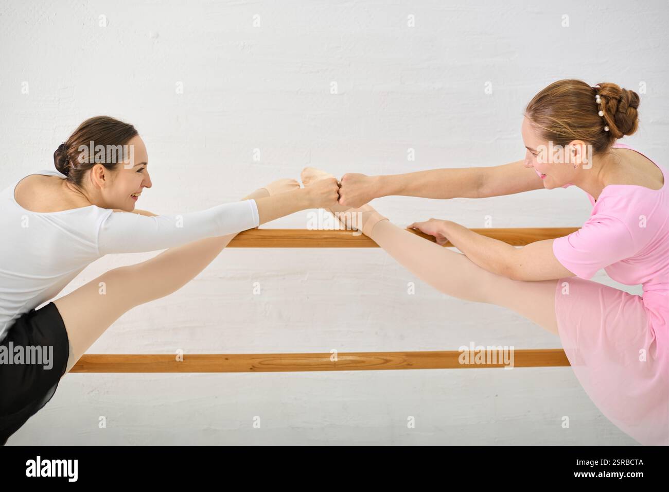 Two young female ballerinas, one with brown hair and one with auburn ...