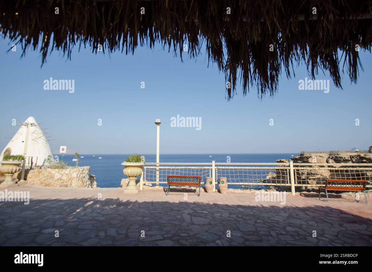 Tranquil resort offers expansive sea view under cool shade of thatch ...
