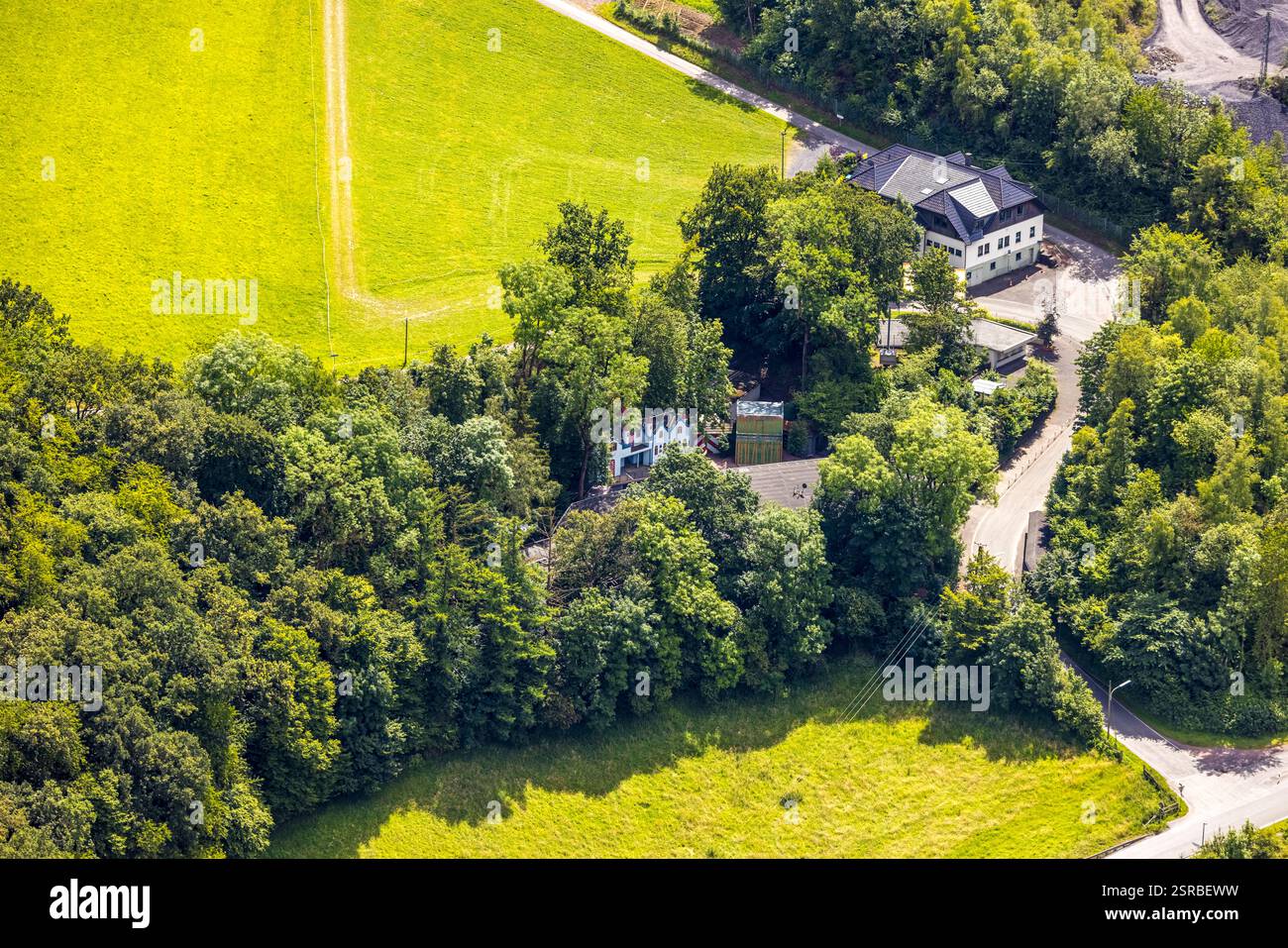 Aerial view, open-air stage covered by trees and adjacent buildings ...