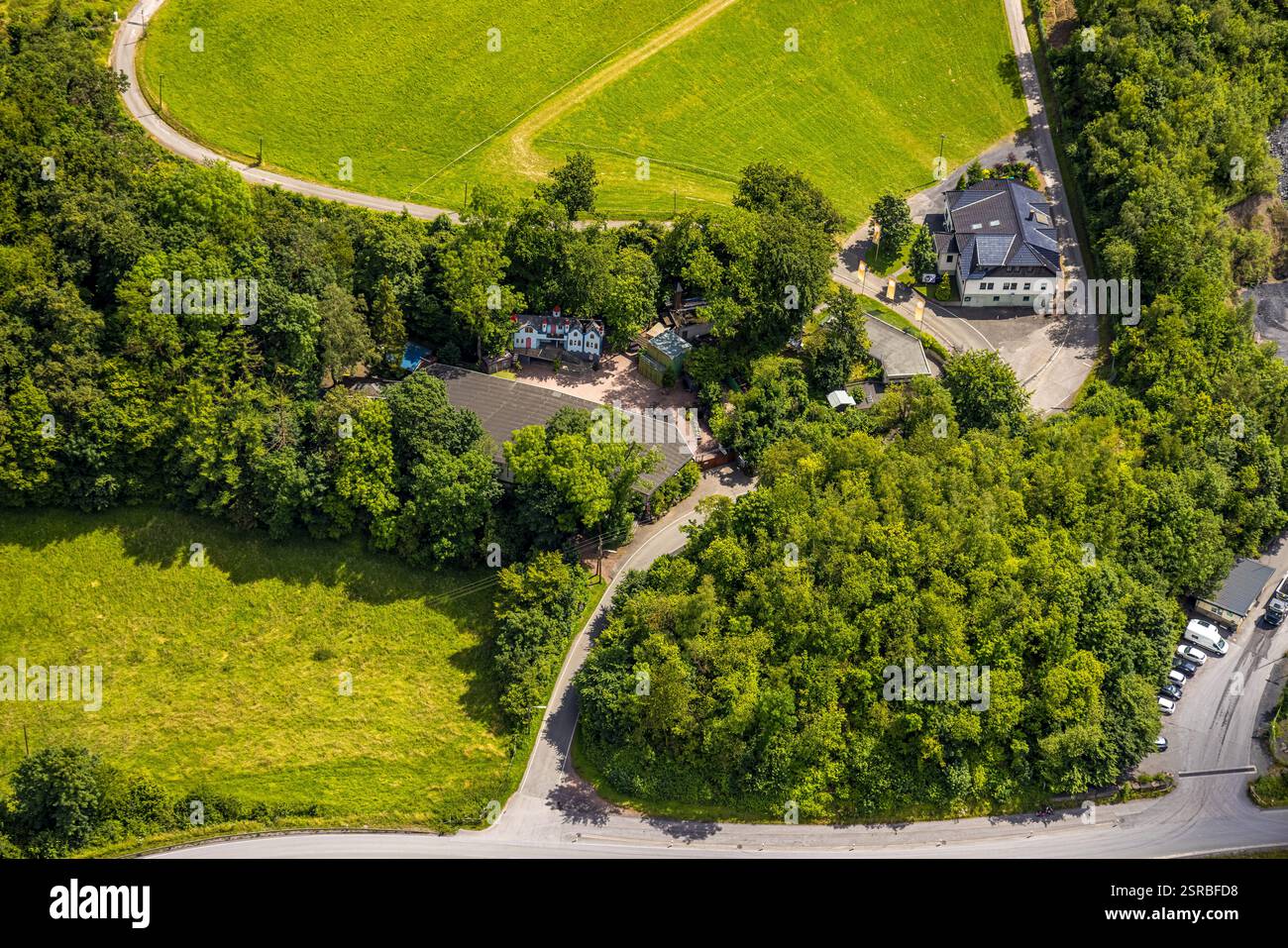 Aerial view, open-air stage covered by trees and adjacent buildings ...