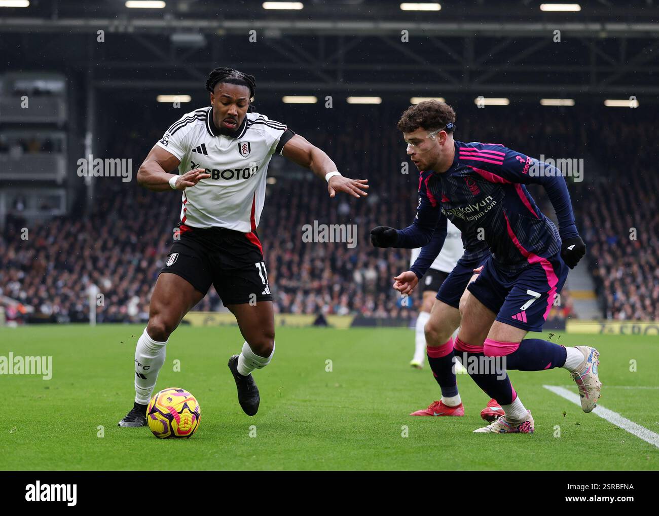 London, UK. 15th Feb, 2025. Adama Traore of Fulham with Neco Williams ...
