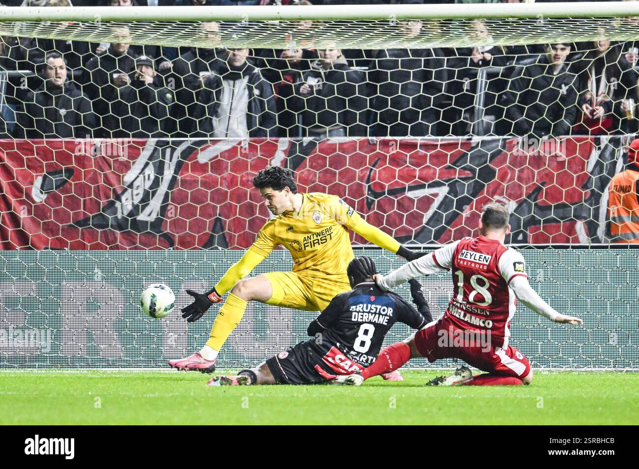 Antwerp, Belgium. 15th Feb, 2025. Antwerp's goalkeeper Senne Lammens, Kortrijk's Karim Dermane ...