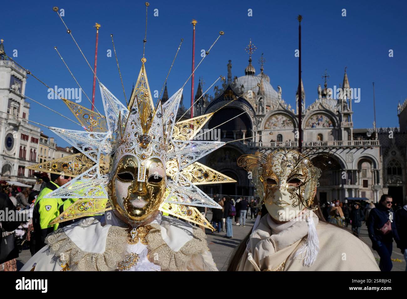 People wear masks in front of the St. Mark's Basilica during the ...