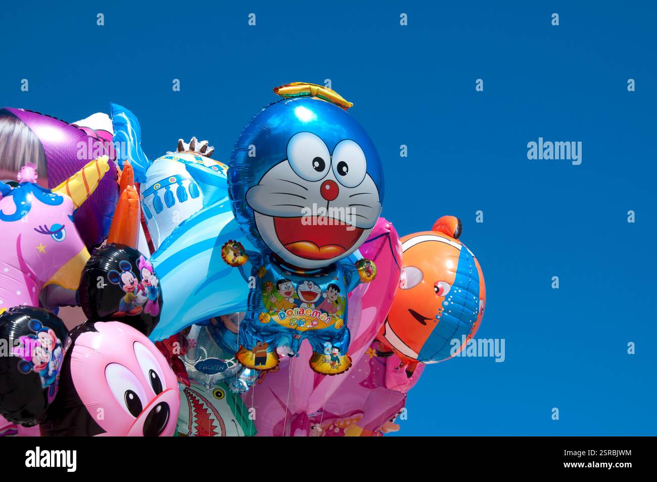 Balloons disney characters Mickey, Nemo, Peppa Pig and Doraemon on sky ...