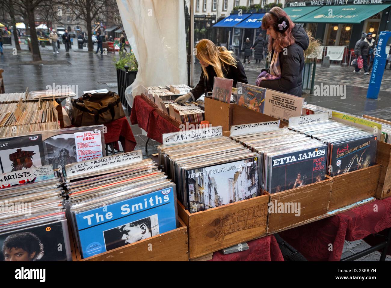 Two young women browsing secondhand records at the Saturday market in ...