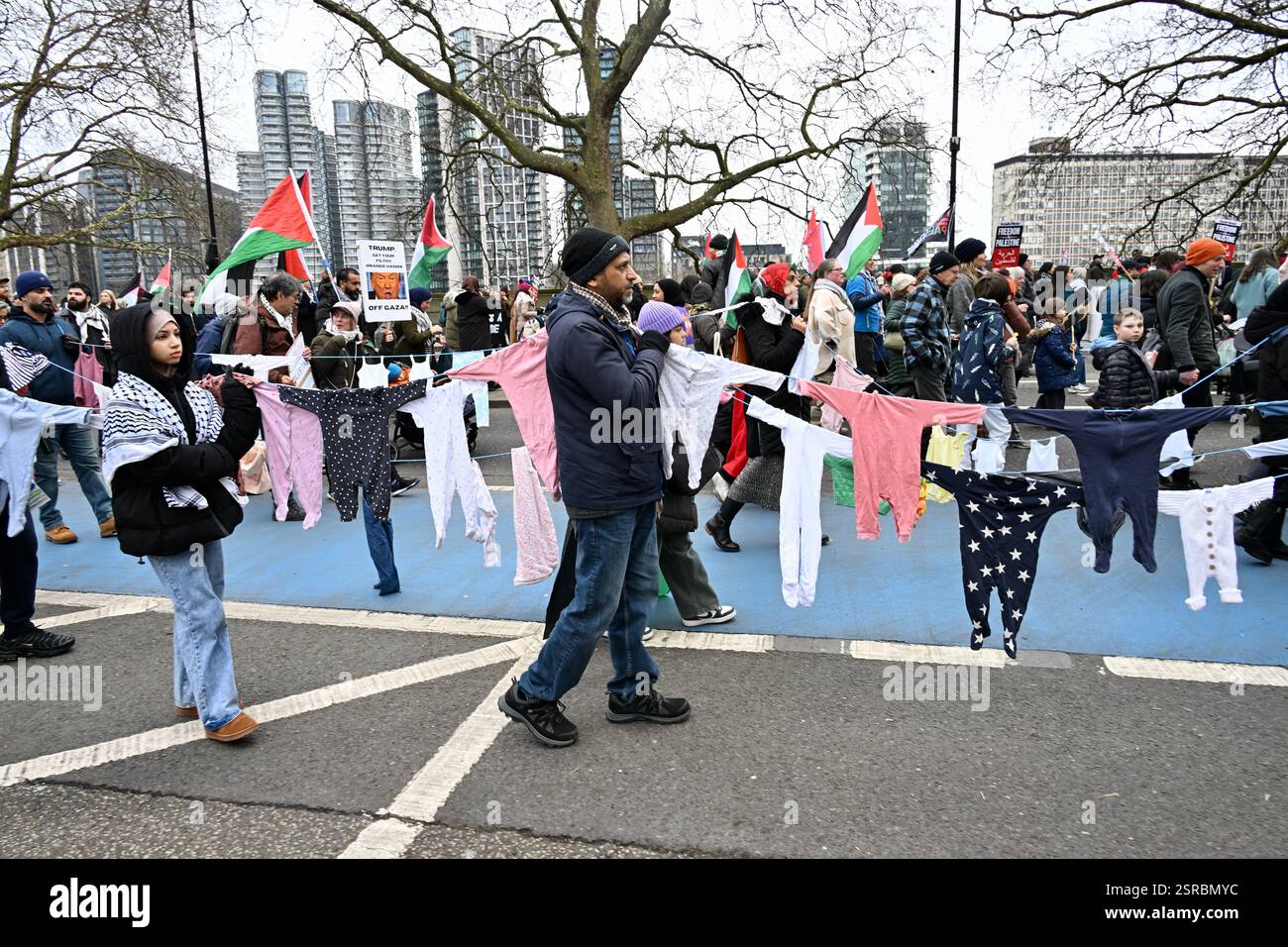 London, UK. Baby clothes hanging on strings symbolise children killed ...