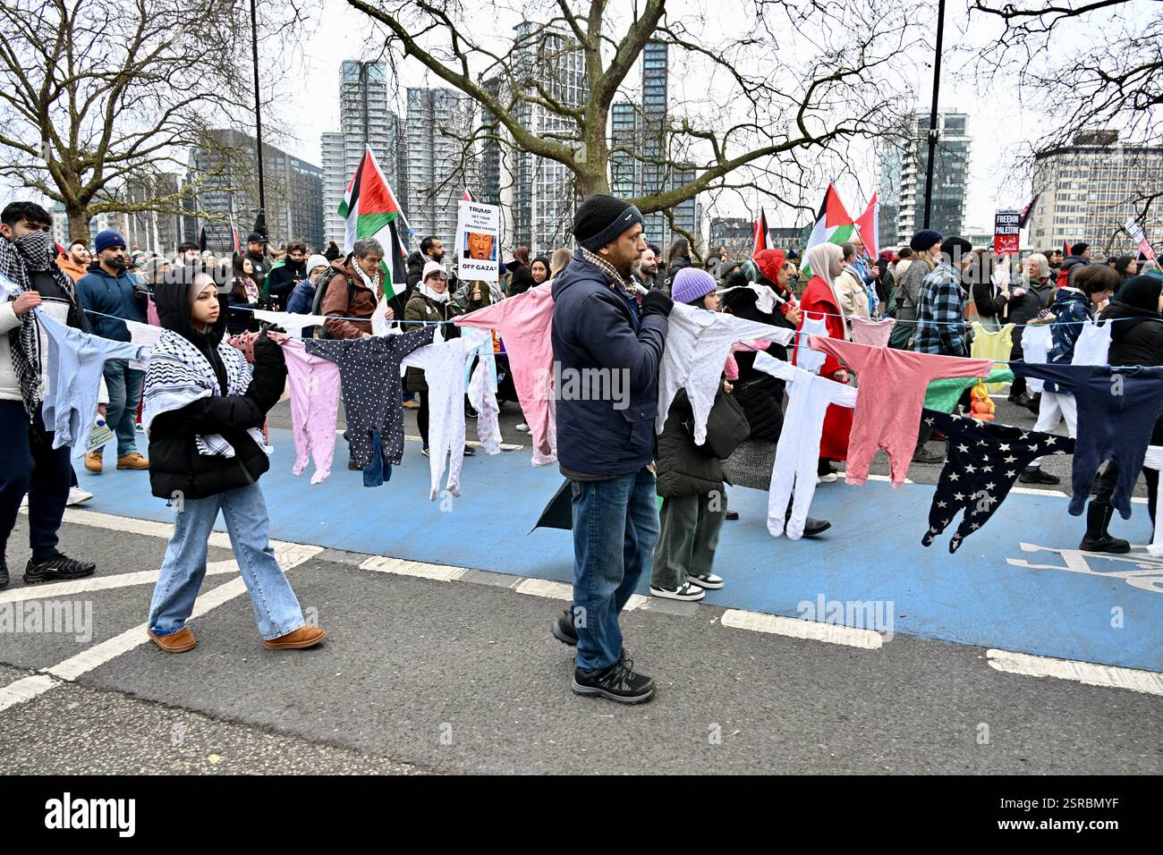 London, UK. Baby clothes hanging on strings symbolise children killed ...