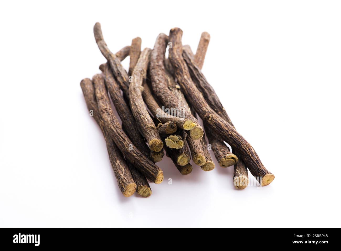 Licorice roots on white background Stock Photo - Alamy