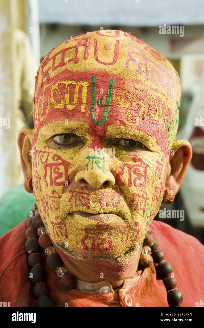 Priest writing radhe krishna on face by sandalwood paste, uttar pradesh ...