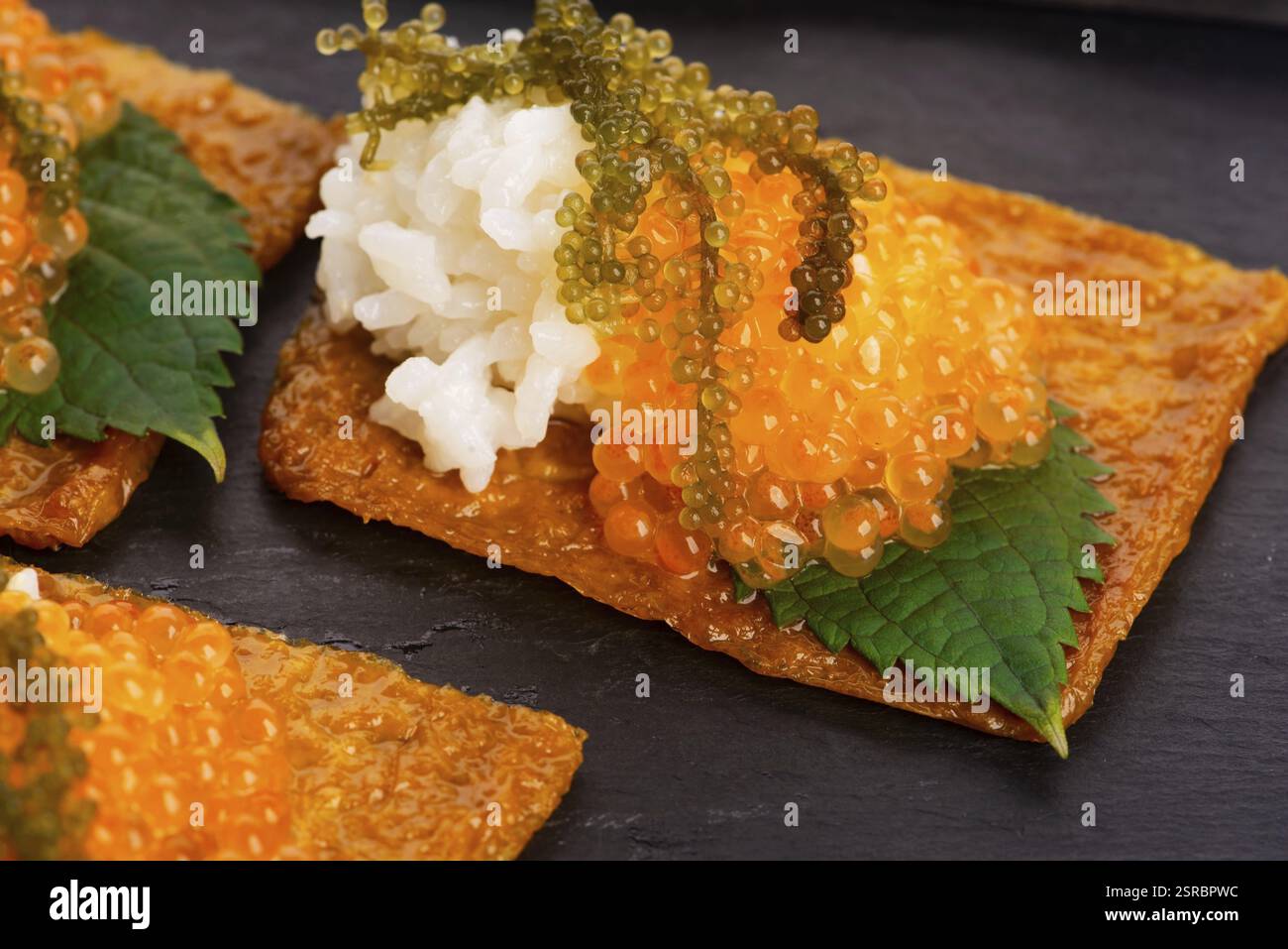 Inari sushi with caviar, rice, shiso and umibudo Stock Photo - Alamy