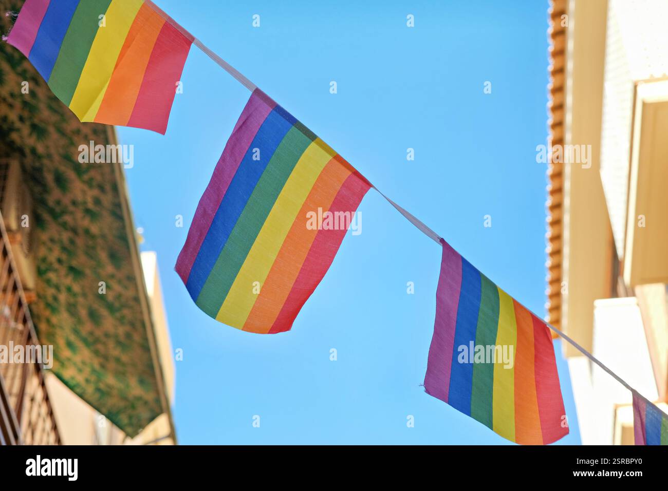 Bunting string with multicolored rainbow flags on building in Benidorm ...