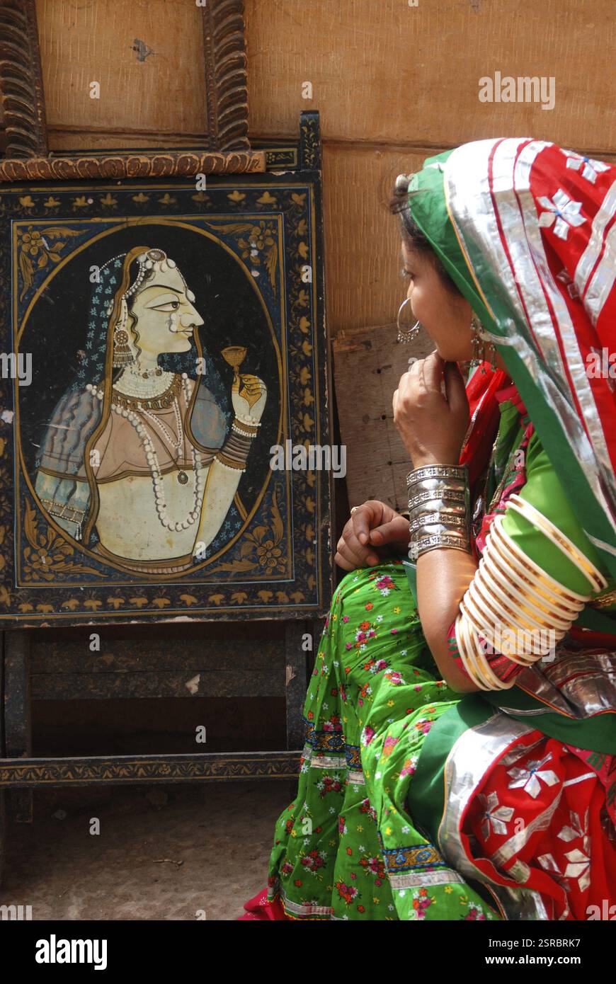 Rajasthani marwari lady in raika community dress looking at painting ...