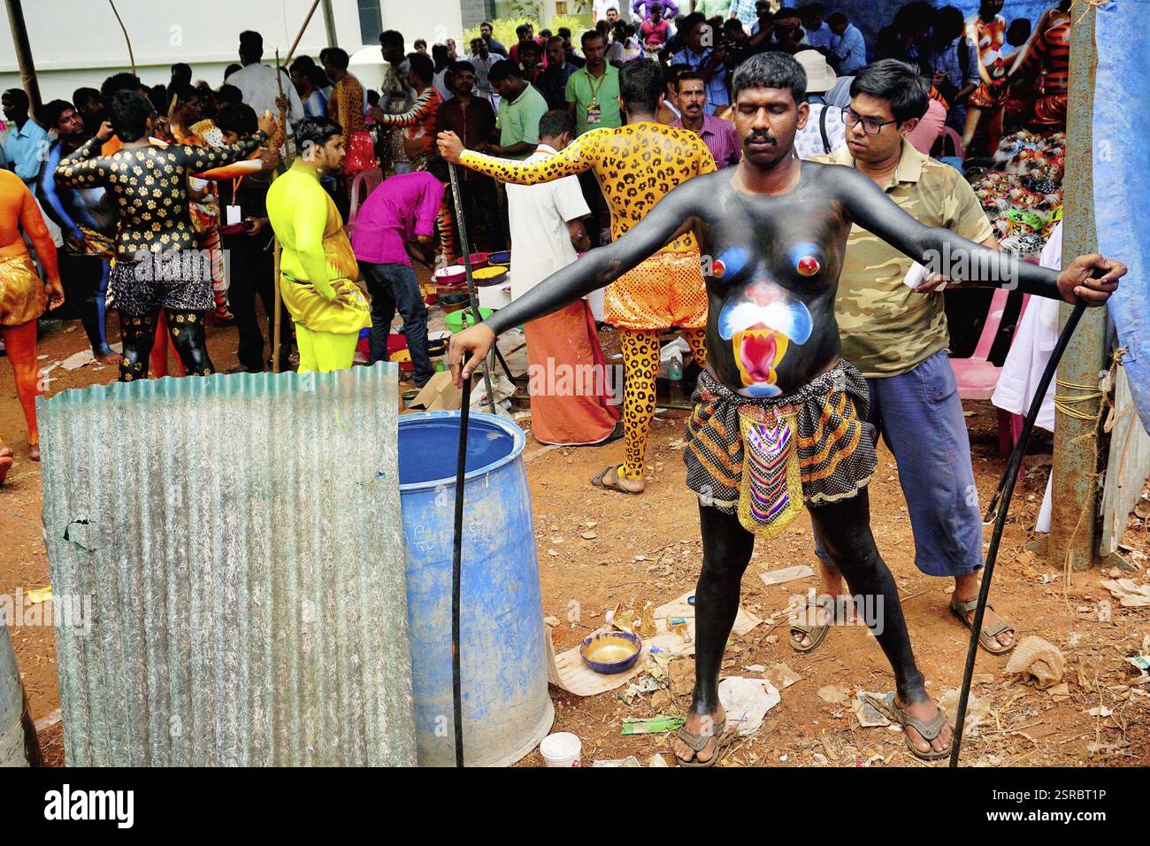 Artists painting bodies for Pulikali Tiger Dance, Onam festival, Kerala ...