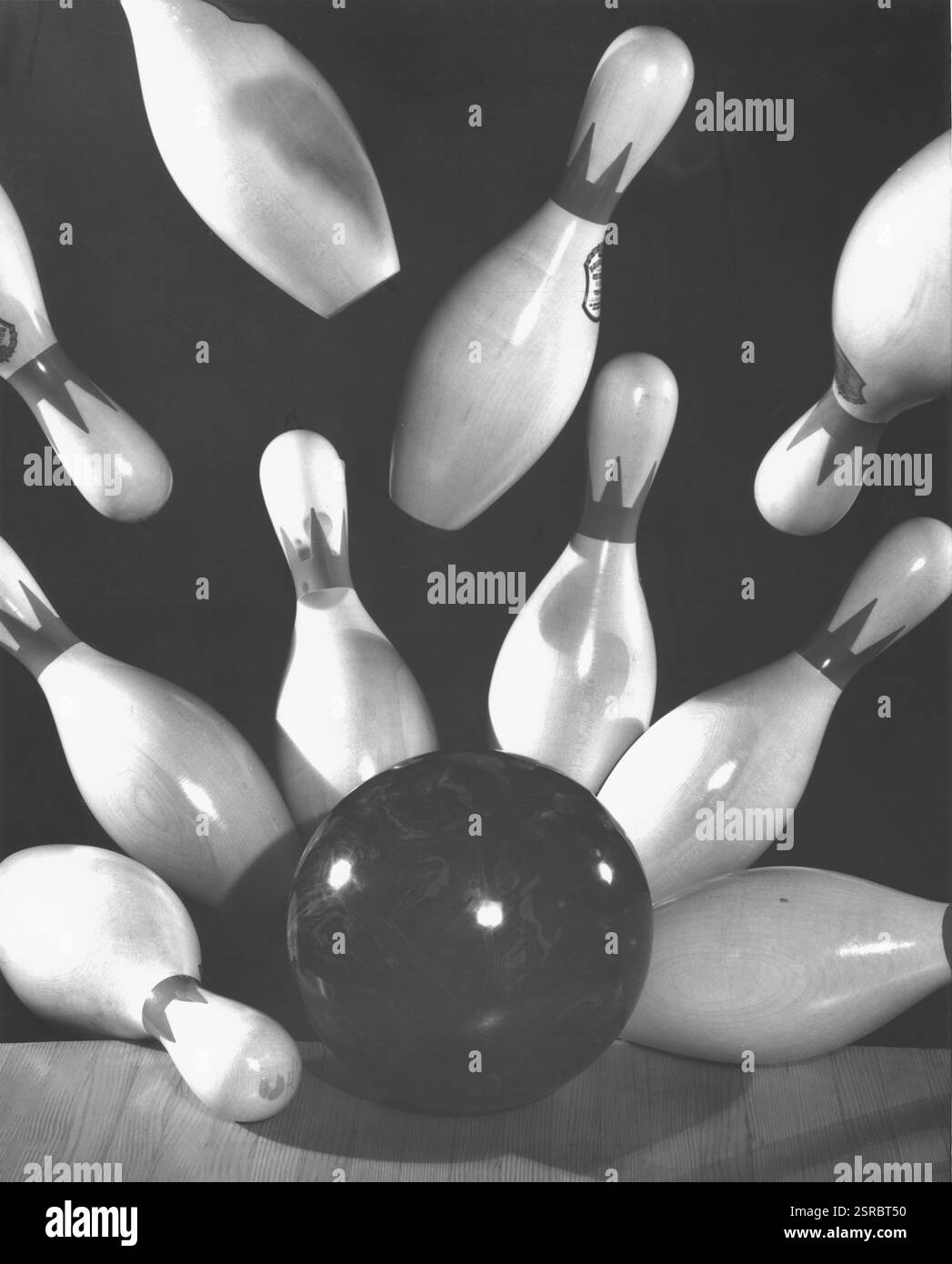 Bowling ball hitting bowling pins and scattering them Stock Photo - Alamy