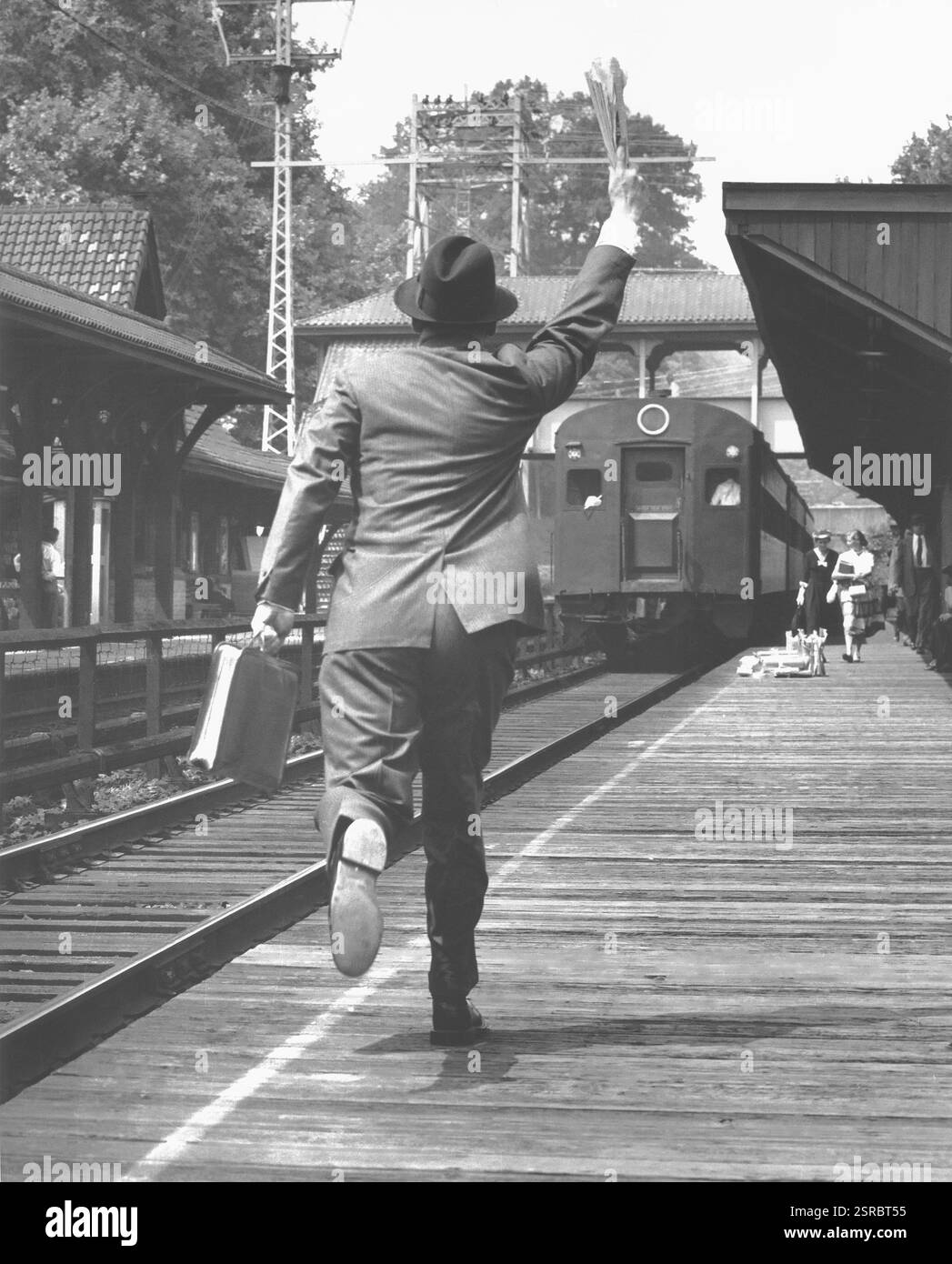 Man walking along platform Black and White Stock Photos & Images - Alamy