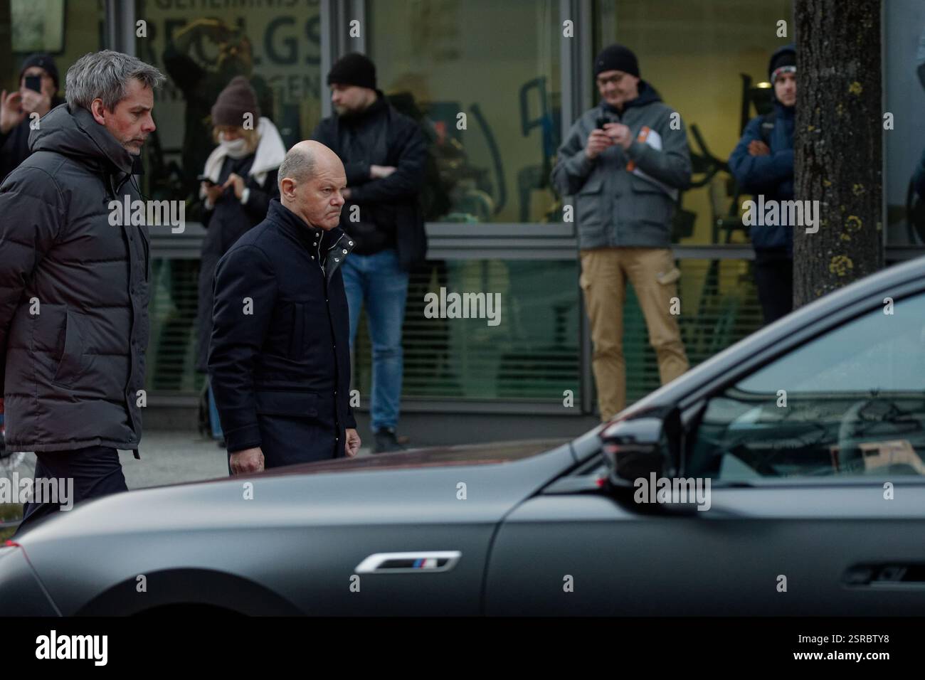 Munich, Germany. 15th Feb, 2025. Chancellor Olaf Scholz (SPD) leaves the site where a car ...