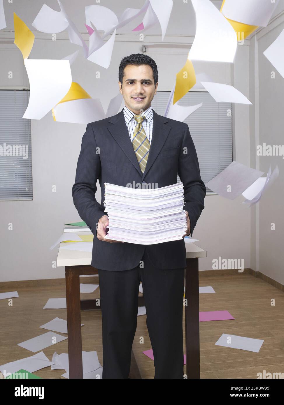 Papers flying around executive holding stack of paper MR#779K Stock ...