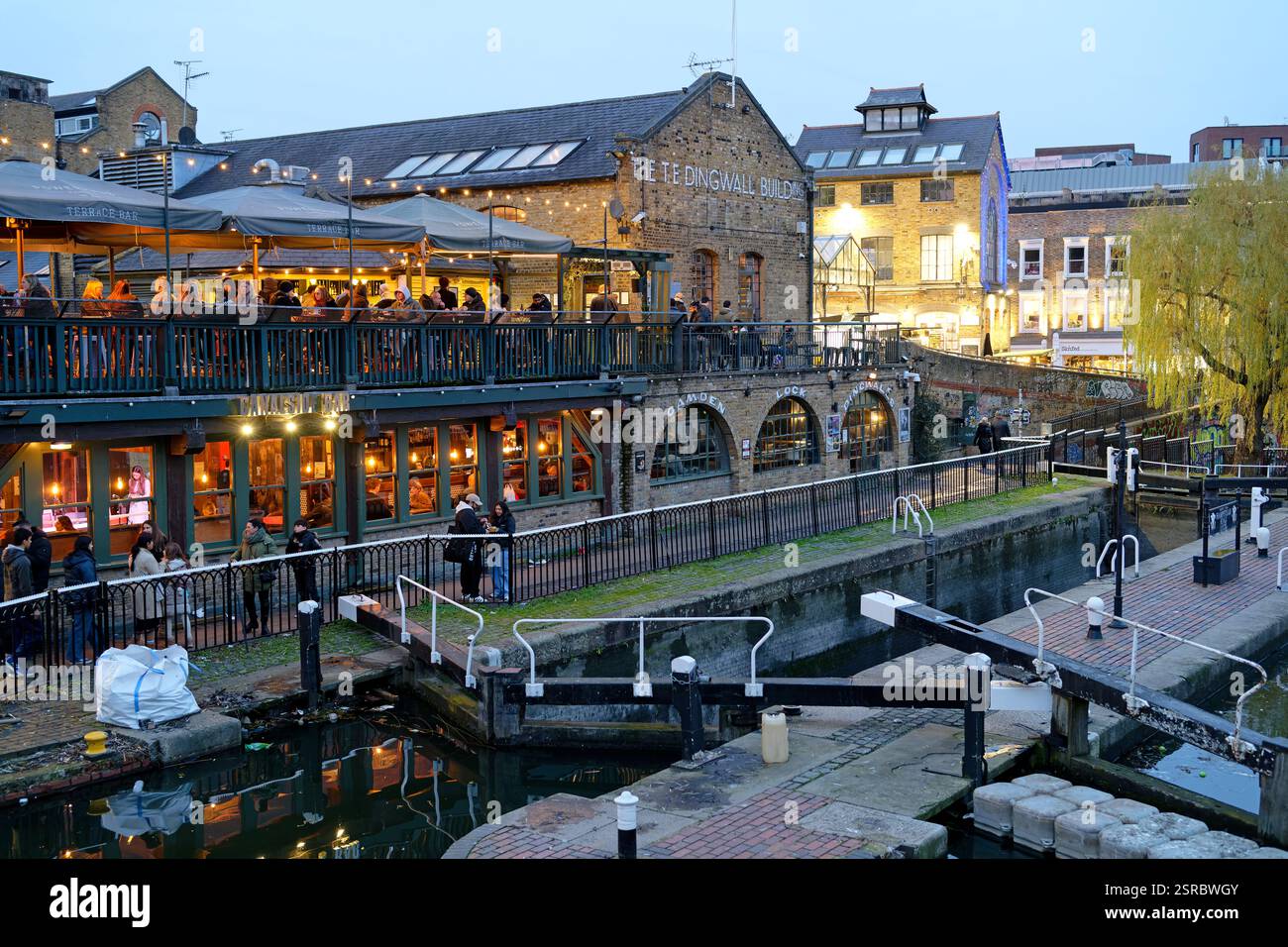 View looking down on Camden Lock on the Regents Canal as lights come on ...