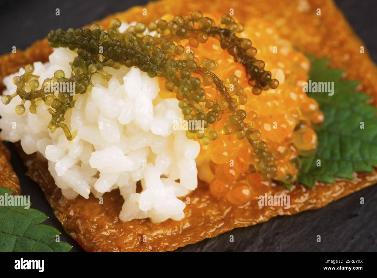 Inari sushi with caviar, rice, shiso and umibudo Stock Photo - Alamy