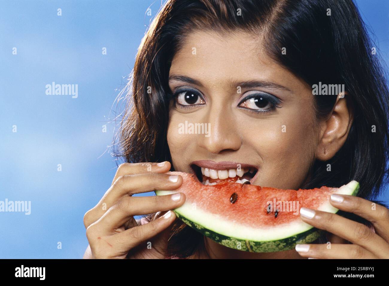 Woman eating melon, India MR#421 Stock Photo - Alamy