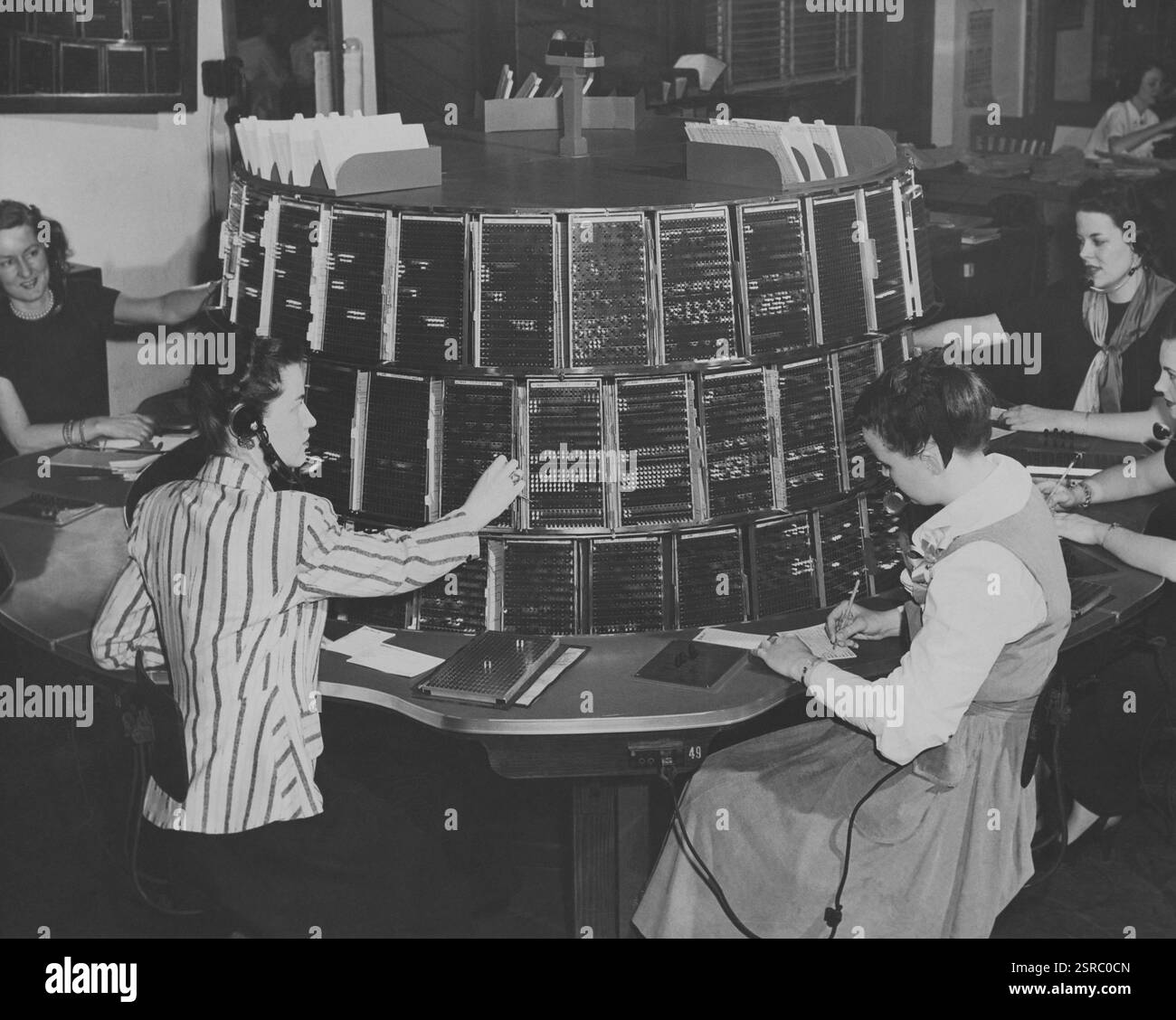 Multiple young women wearing headsets that have microphones attached ...