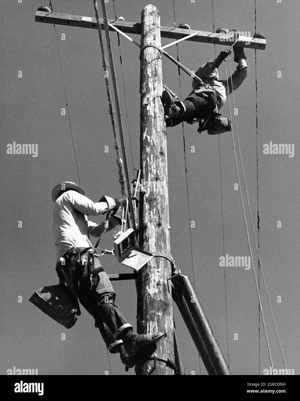 Man working on electric pole Black and White Stock Photos & Images - Alamy