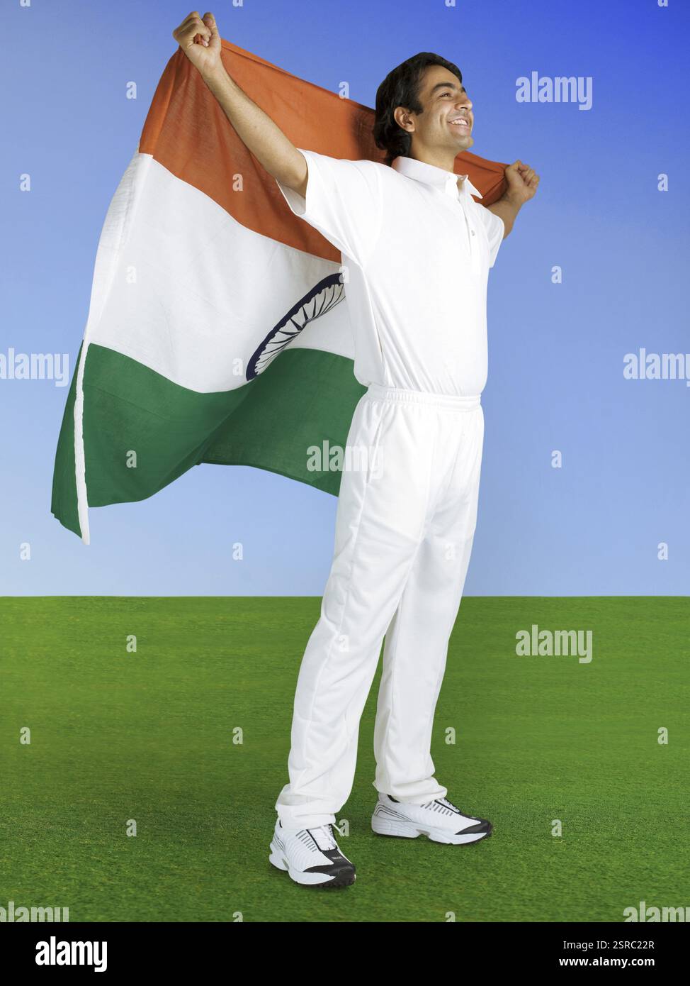 Cricketer holding national flag of India on his backside standing on ...