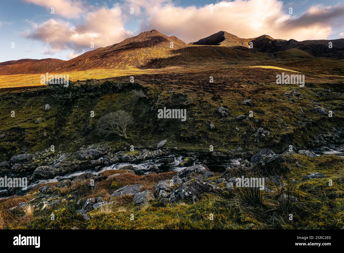 Stunning landscape showcasing rugged mountains illuminated by warm ...