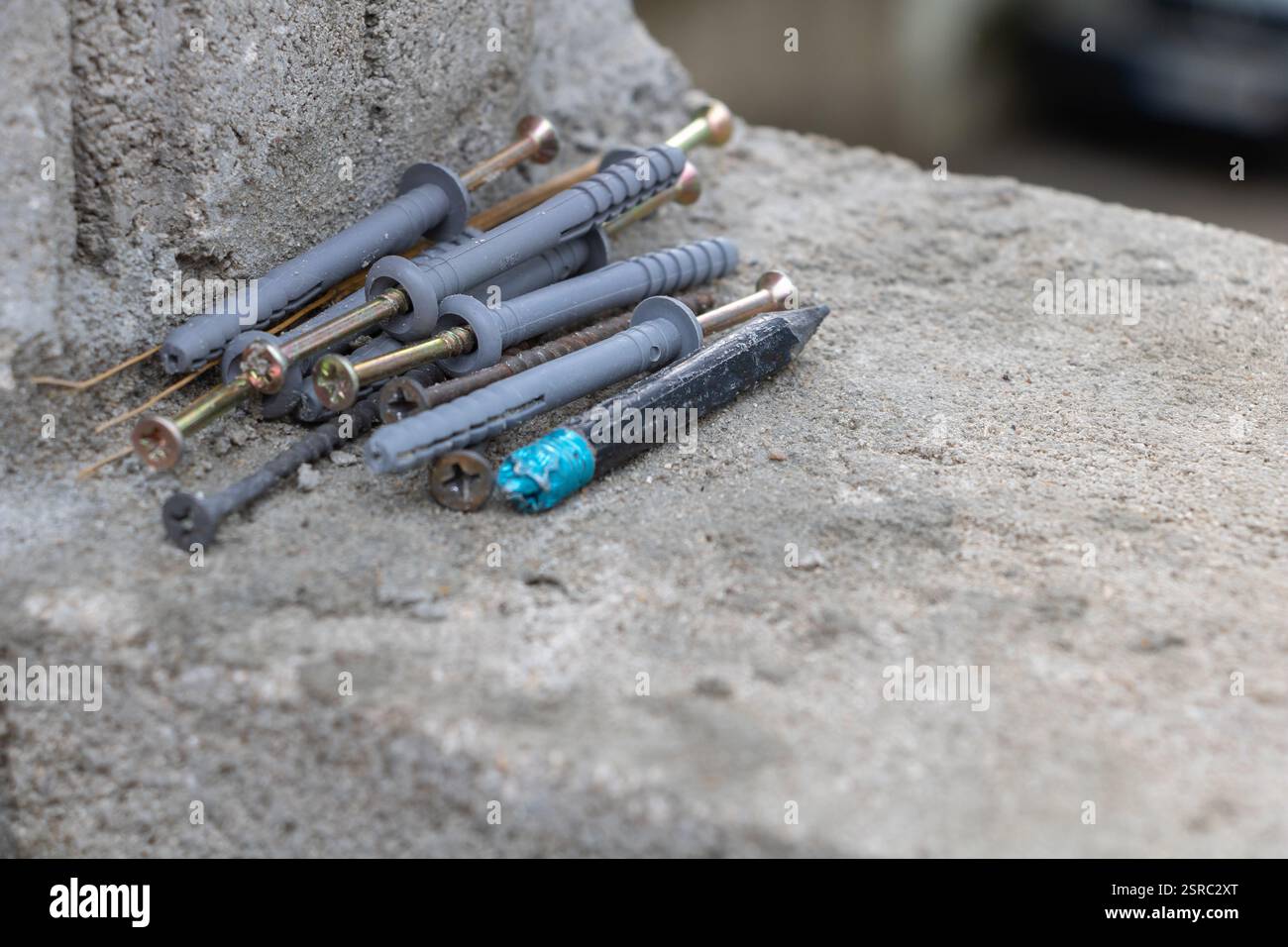 Different types and sizes of fasteners on the concrete wall Stock Photo ...