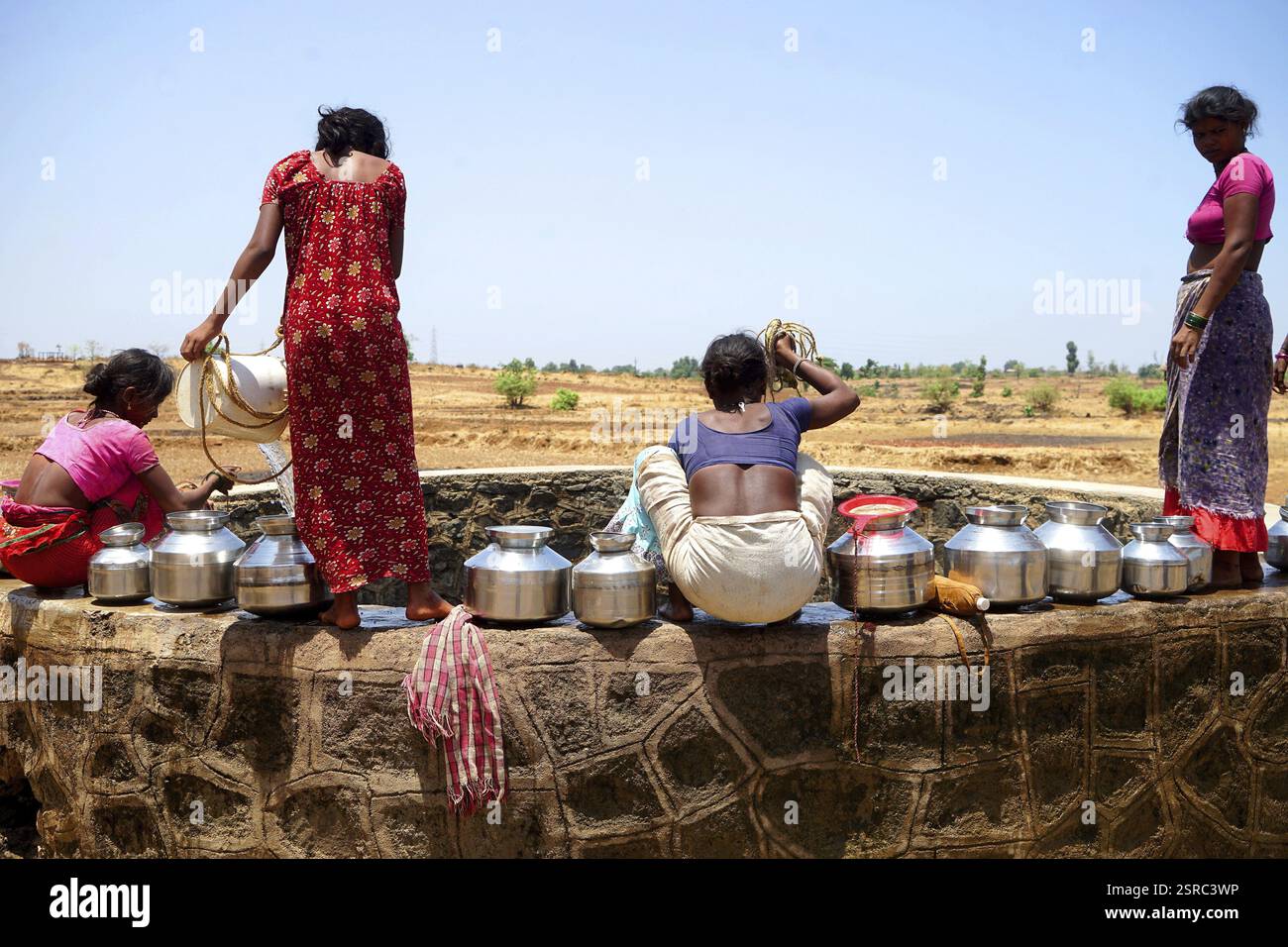 Women collecting water from well at Dhakne village, Shahapur Thane ...