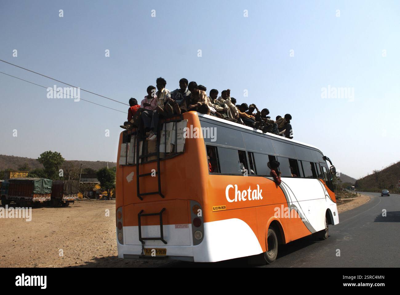 People travelling on rooftop of private transport bus on Udaipur ...