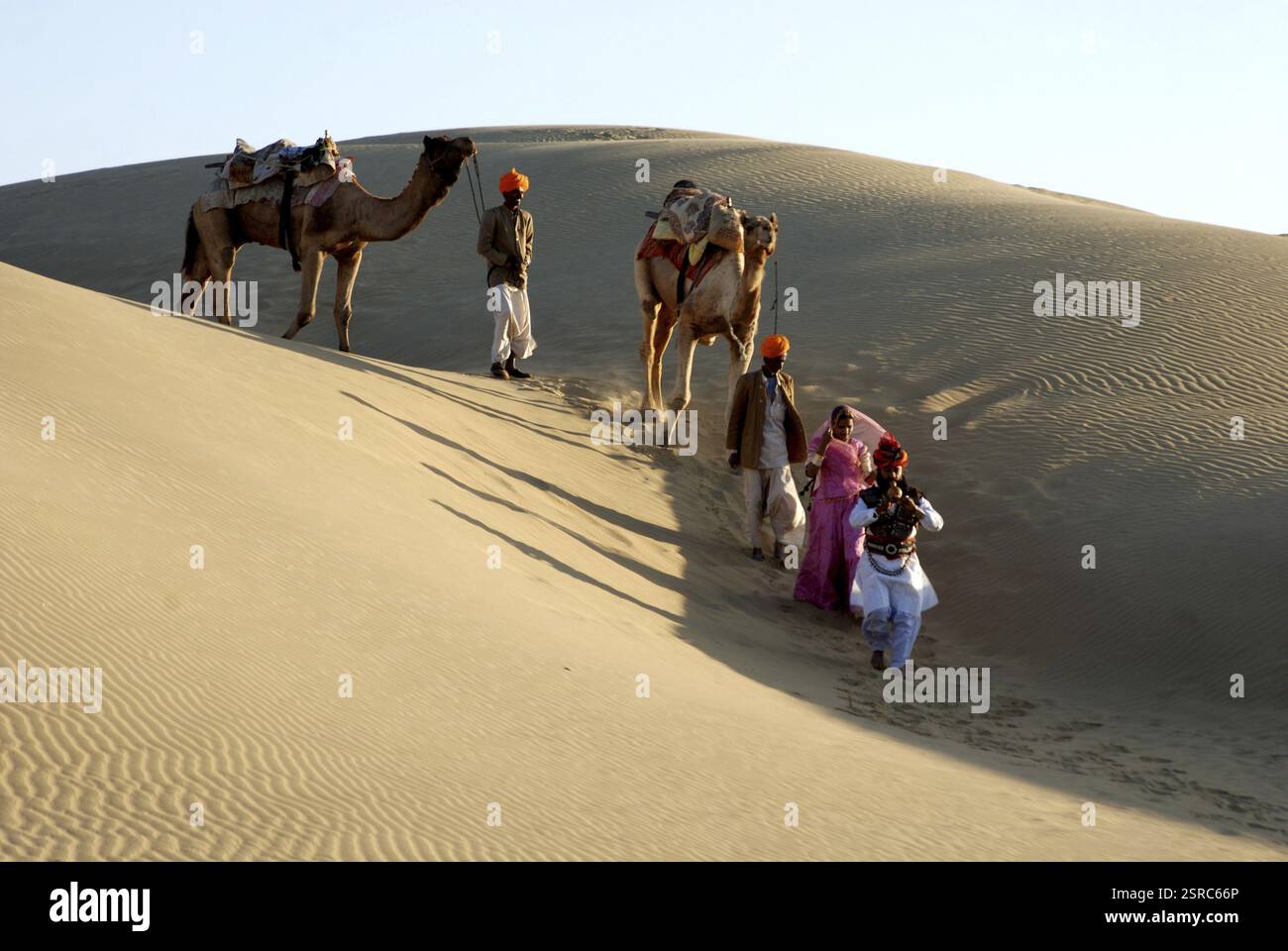 People with camels walking in sand dunes, Khurri, Jaisalmer, Rajasthan ...