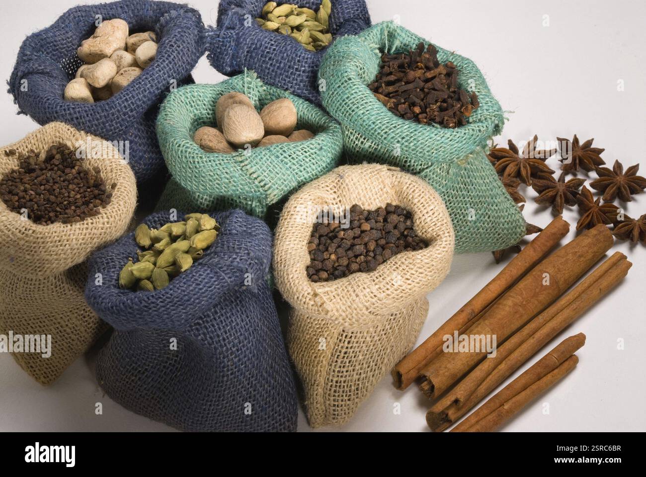 Mix spices in jute sack on white background Stock Photo - Alamy