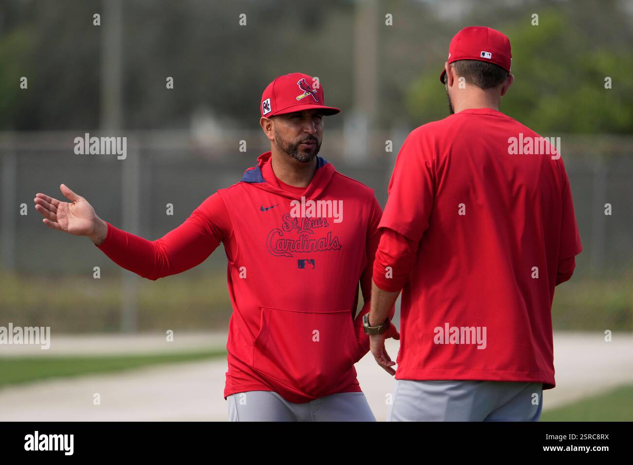 St. Louis Cardinals manager Oliver Marmol, left, talks with pitching ...