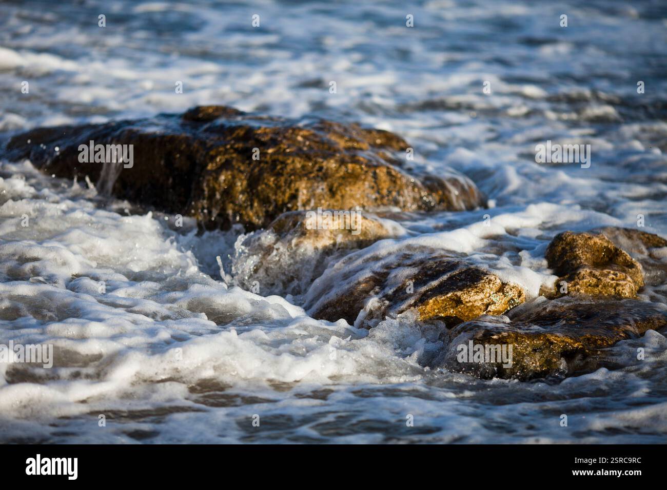 Rock Sea stones with texture surface with blurry blue ocean, cloud sky ...