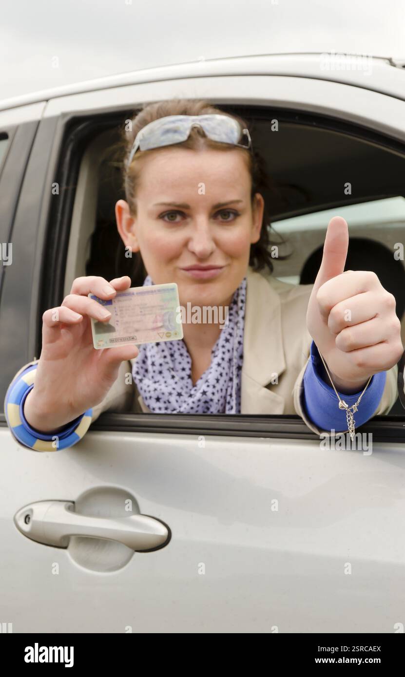 Woman with driving licence Stock Photo - Alamy