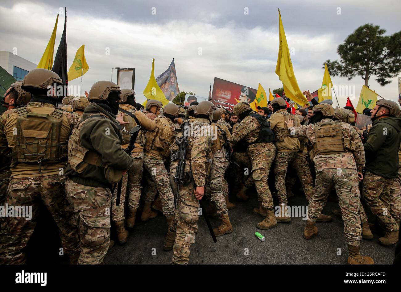 Beirut, Lebanon. 15th Feb, 2025. Protesters wave Hezbollah flags and ...