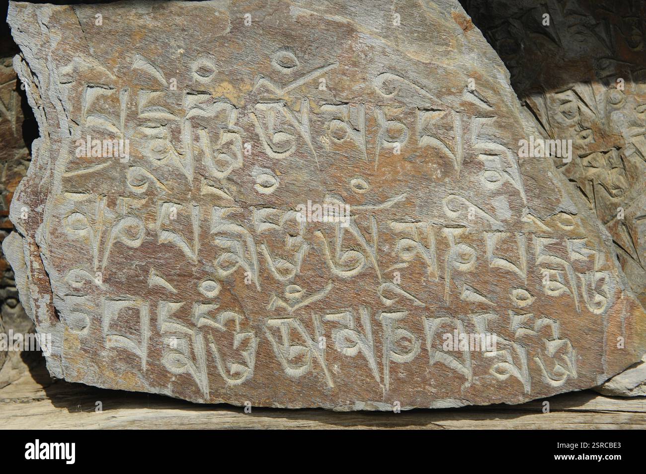Stone engraved with buddhist mantra at dhukur pokhari pisang, Nepal ...