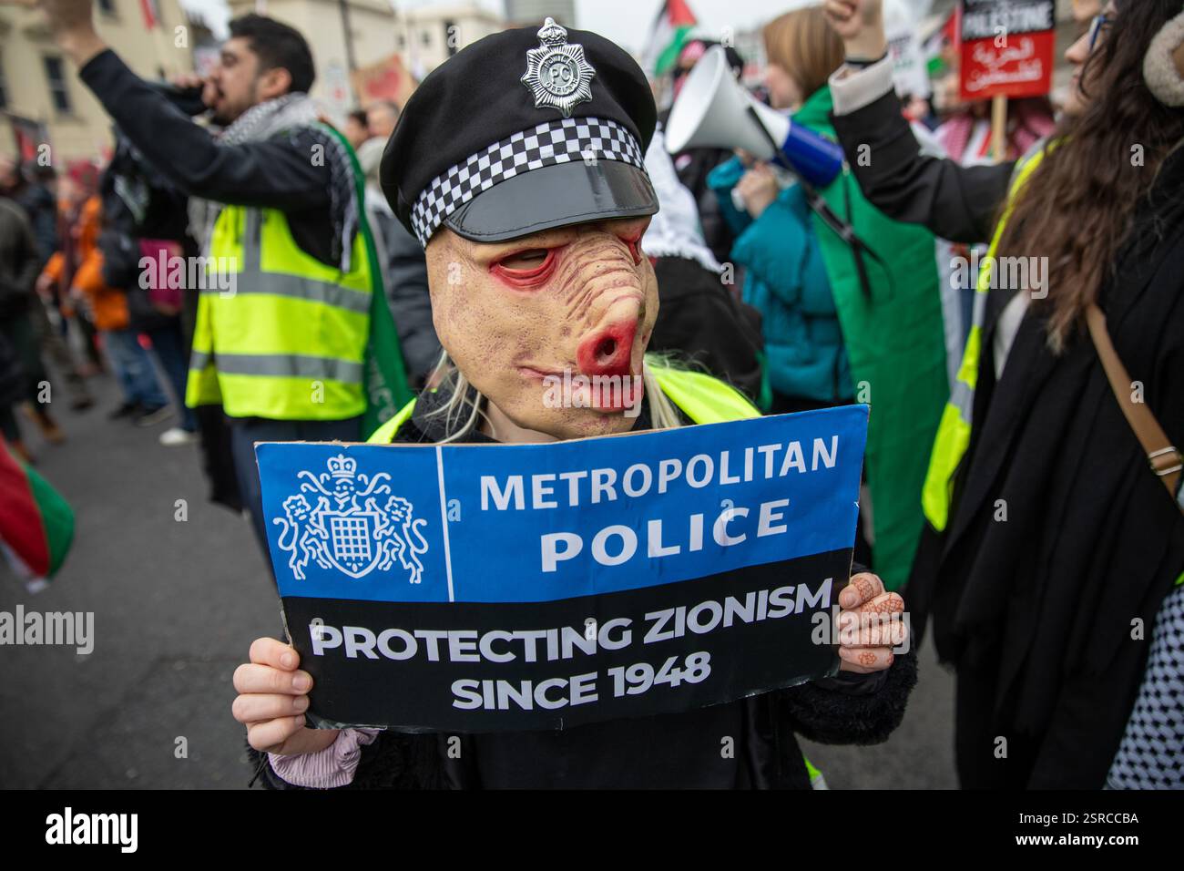 London, UK, 15th February 2025. A demonstrator wearing a piog mask ...