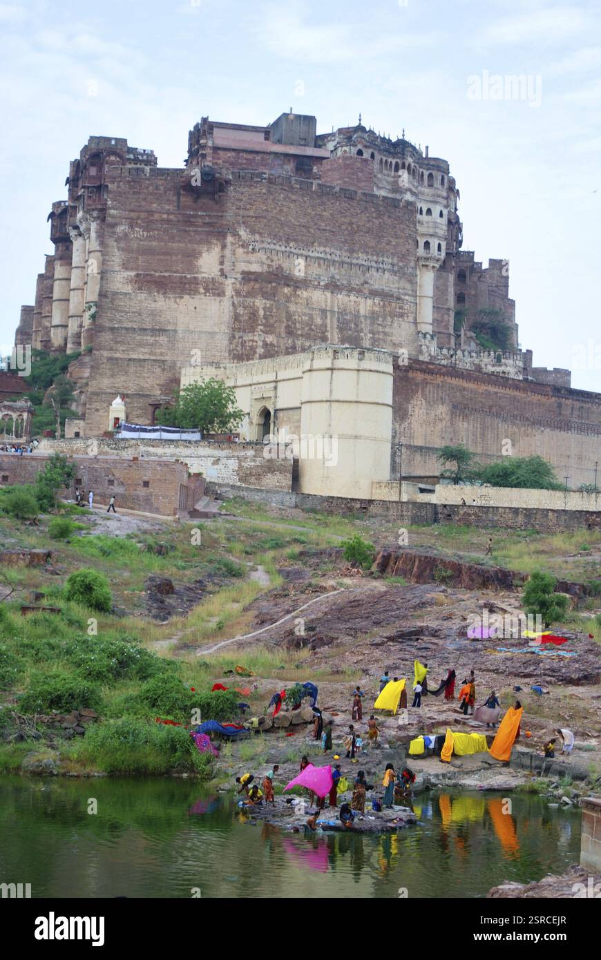 Pilgrims of baba ramdeo bathing in pond at foot hill of mehrangarh fort ...