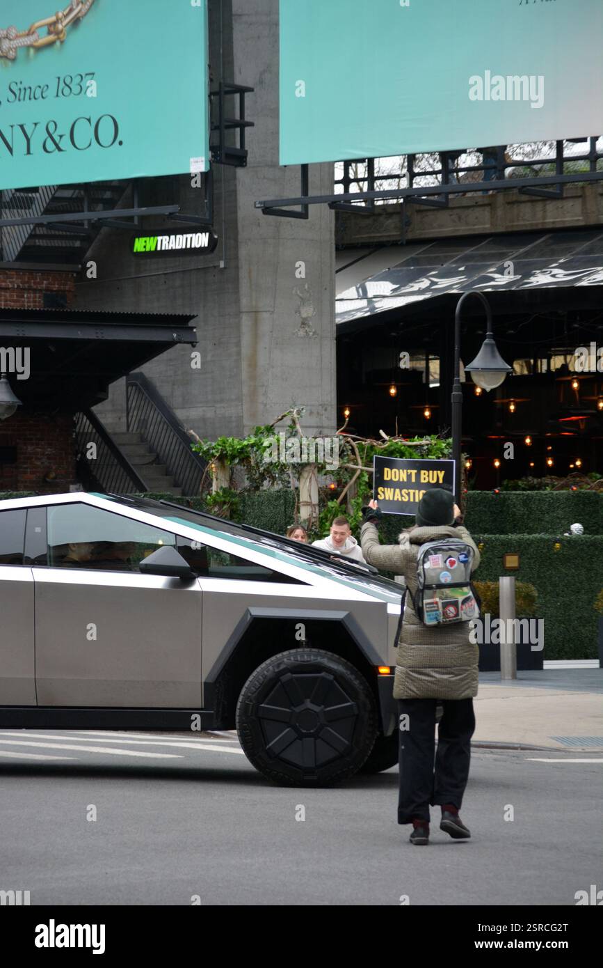 Protester confronting a cybertruck at a "Tesla Takeover" event against ...
