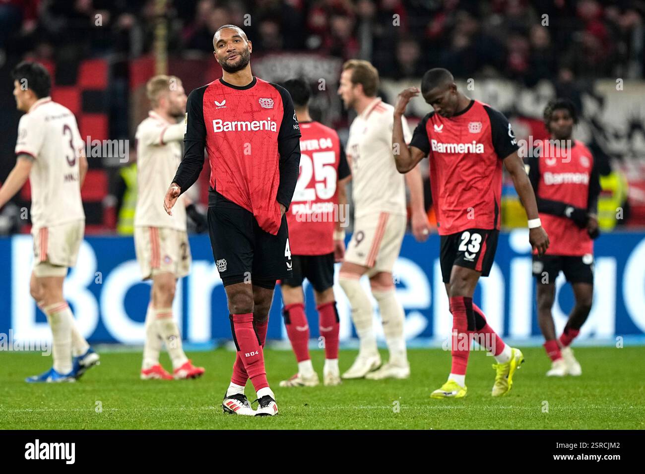 Leverkusen's Jonathan Tah, centre left, reacts after the German ...