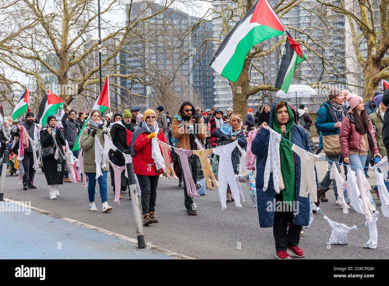 Millbank, London, UK. 15th February 2025. Pro Palestine activists hold a washing line of baby ...