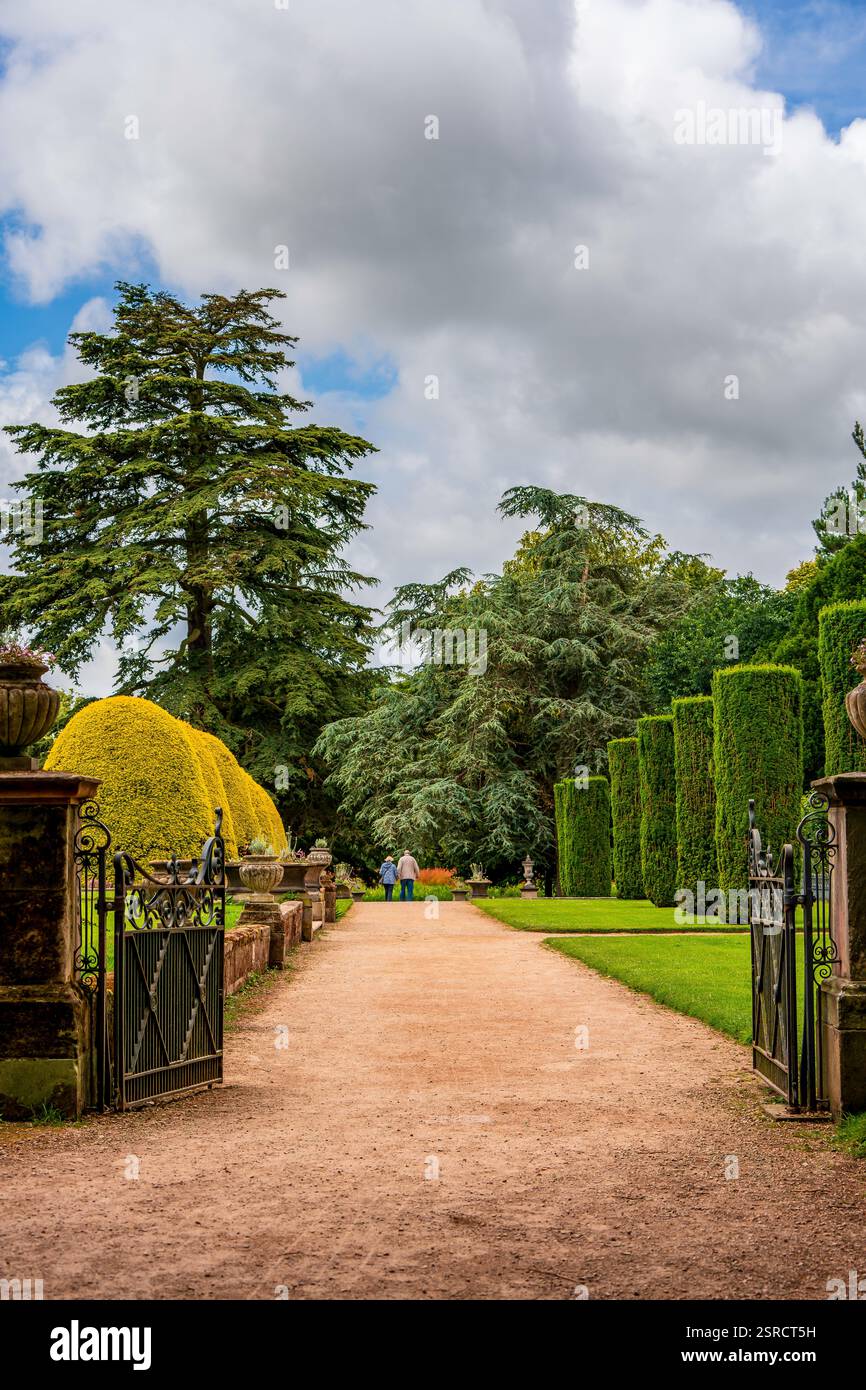 Majestic Garden Path with Ornamental Gates and Lush Topiary in the ...