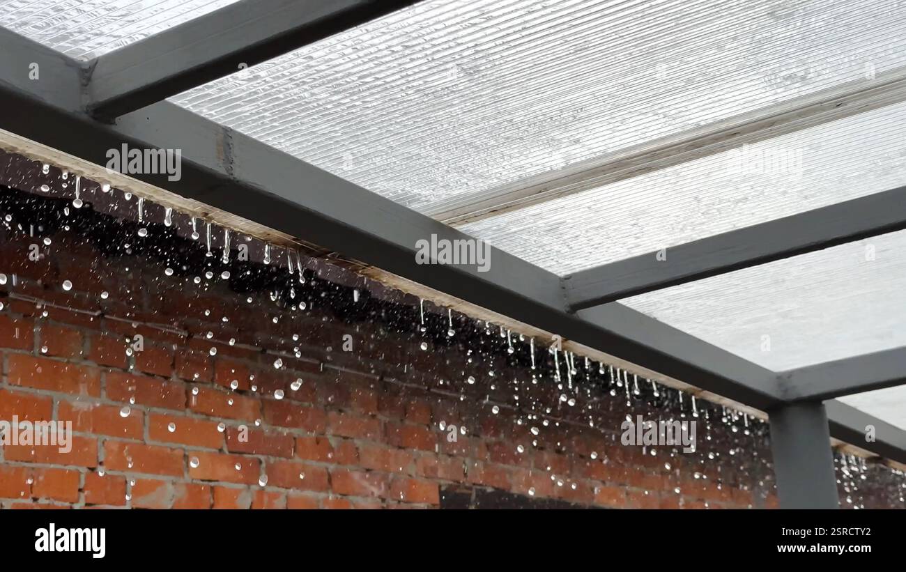 Heavy rain drumming on the transparent plexiglass roof. Beautiful rainy ...
