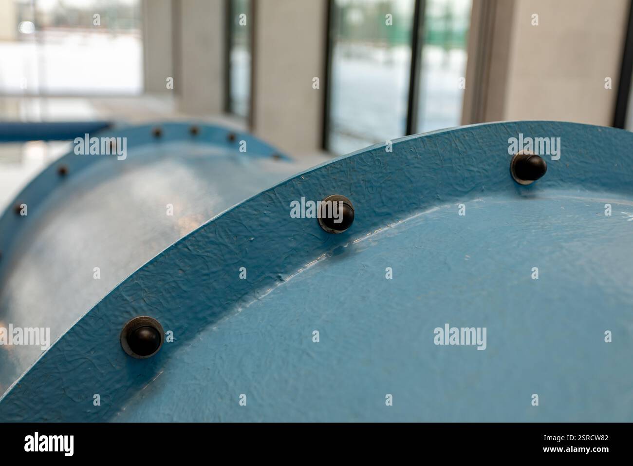 This image captures a detailed closeup of a blue industrial pipe ...