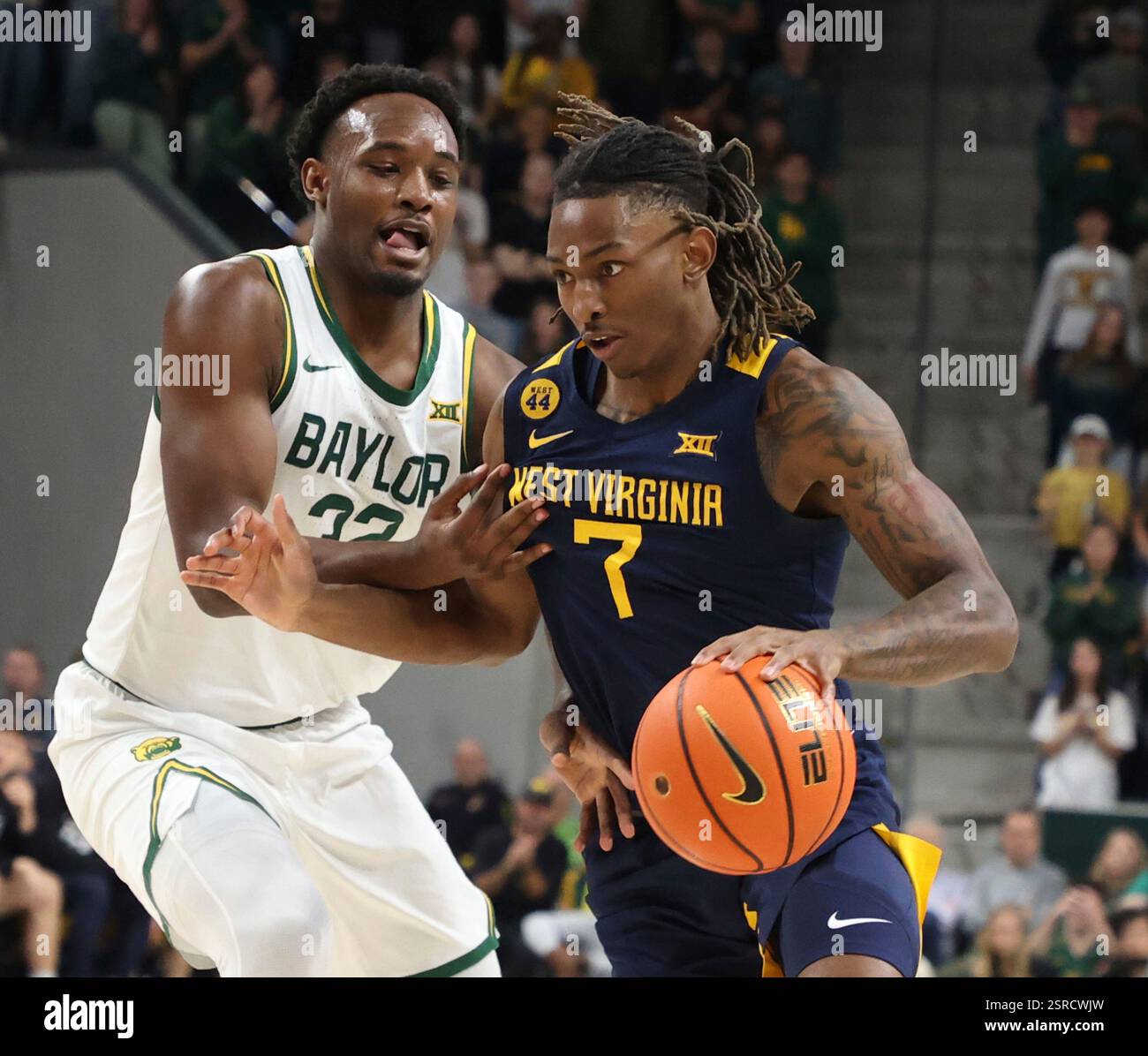 West Virginia guard Javon Small drives on Baylor guard Jalen Celestine ...