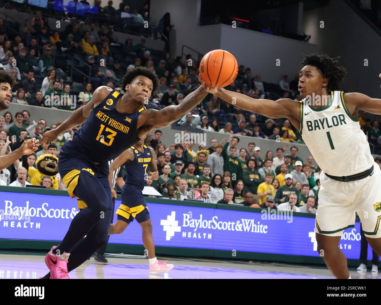 West Virginia forward Amani Hansberry reaches for a loose ball with ...
