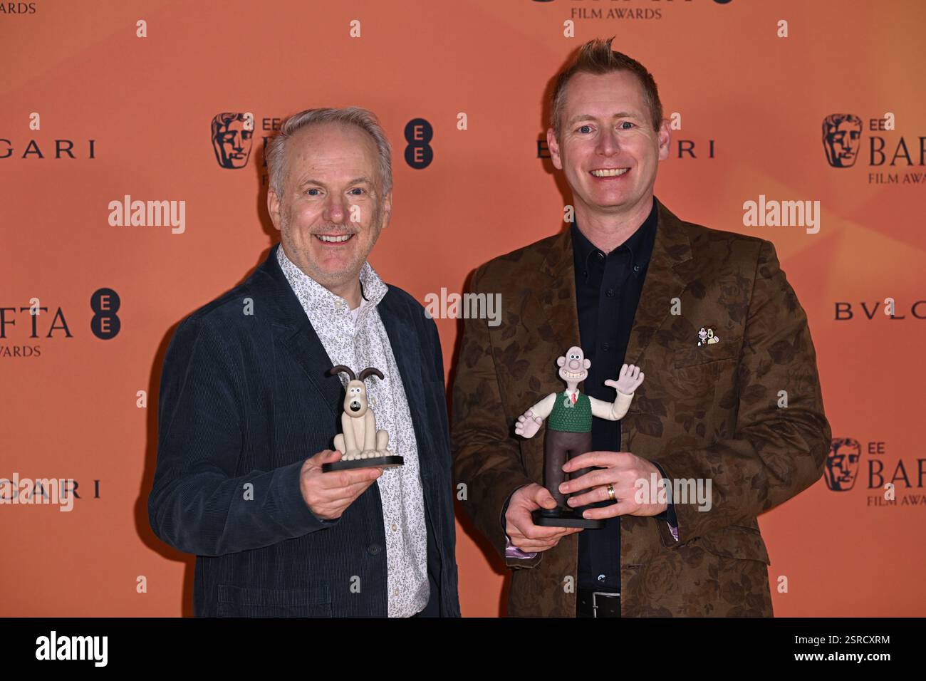 Nick Park and Merlin Crossingham (right) arriving for the EE Bafta Film ...
